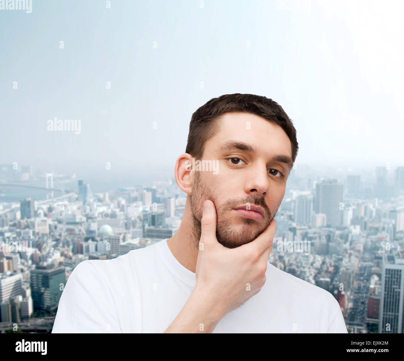beautiful calm man touching his face Stock Photo - Alamy