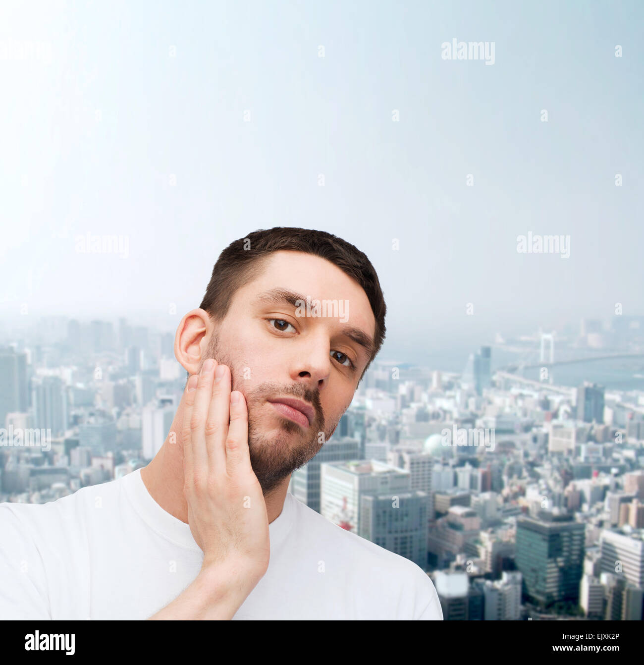 beautiful calm man touching his face Stock Photo - Alamy