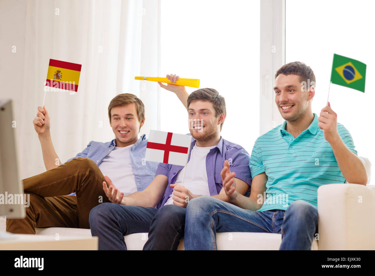 happy male friends with flags and vuvuzela Stock Photo - Alamy