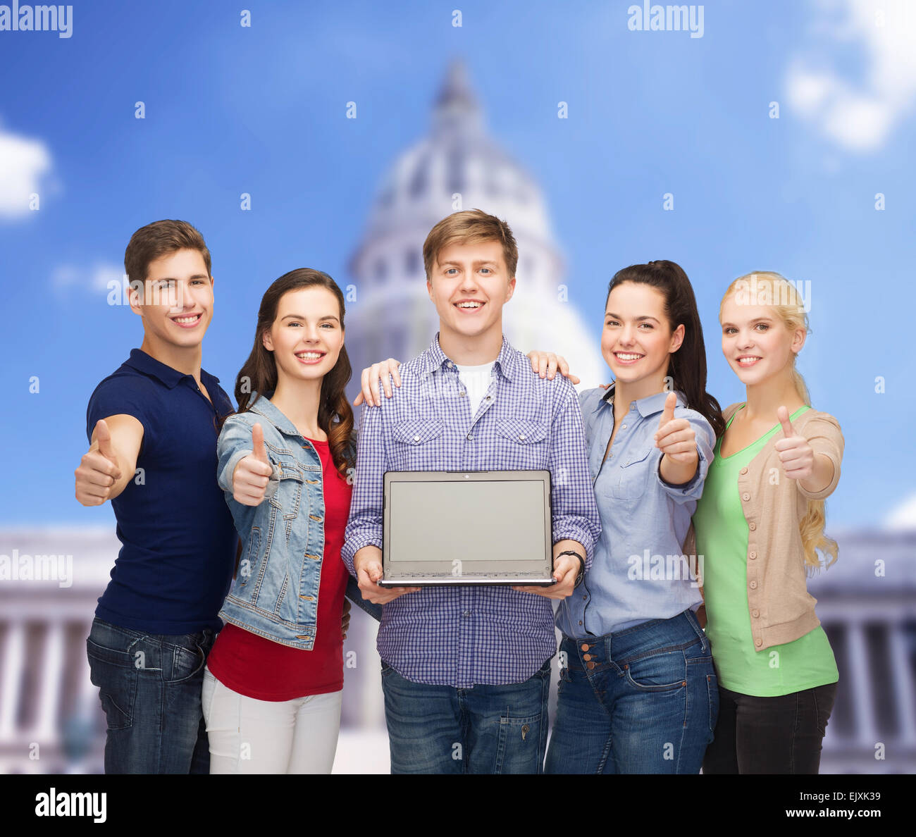 smiling students with laptop computer Stock Photo - Alamy