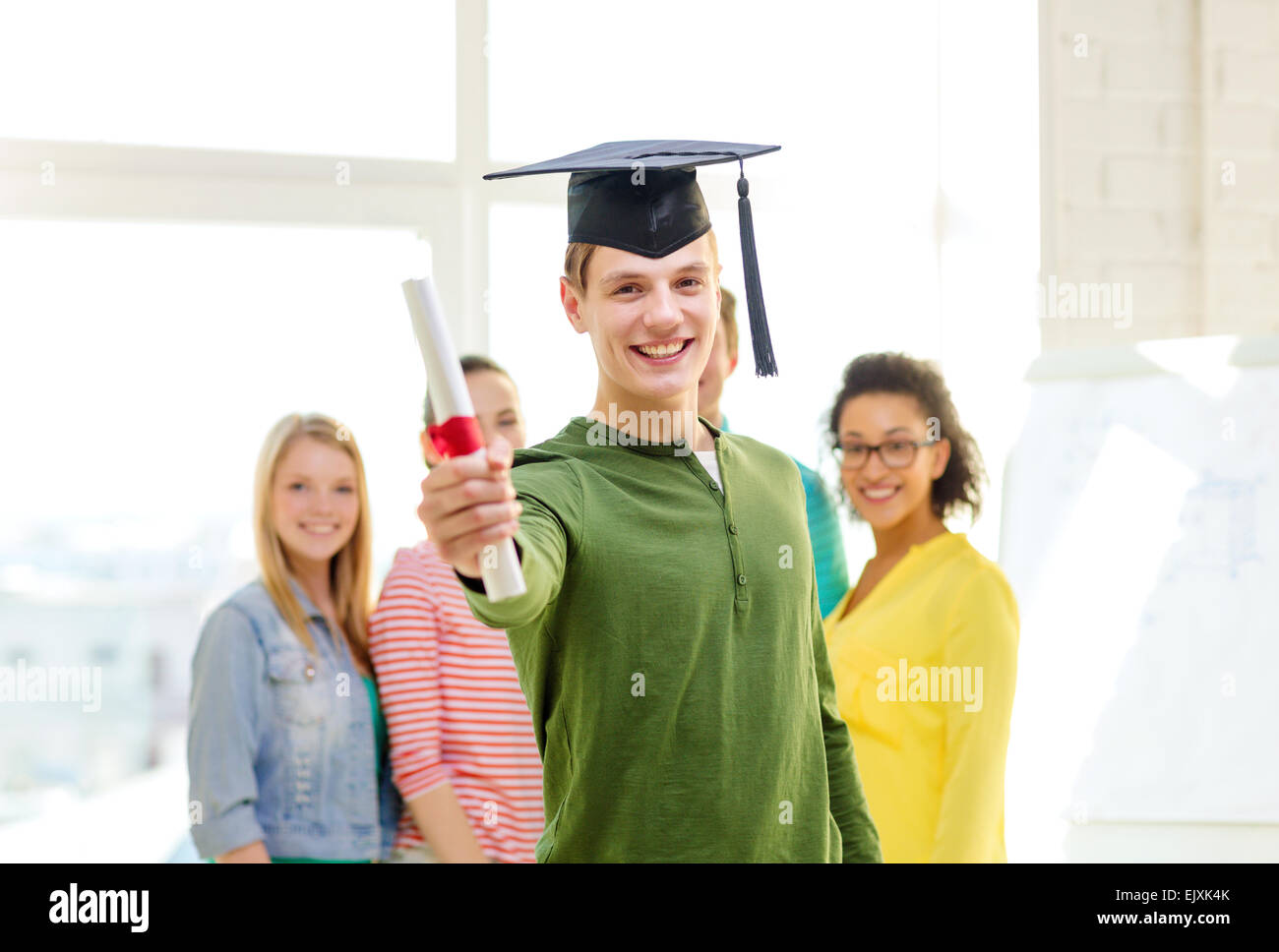 smiling male student with diploma and corner-cap Stock Photo - Alamy