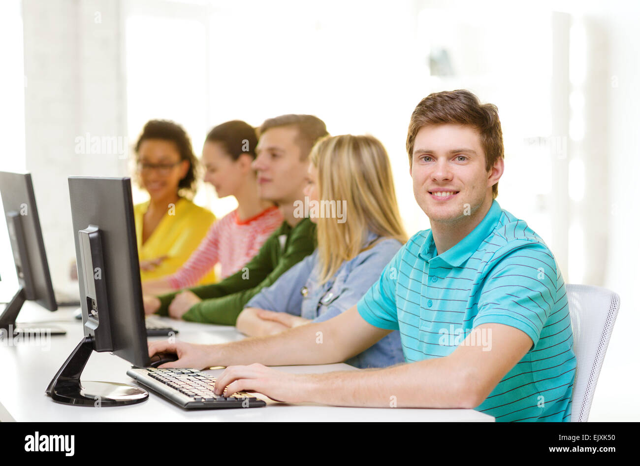 male student with classmates in computer class Stock Photo - Alamy