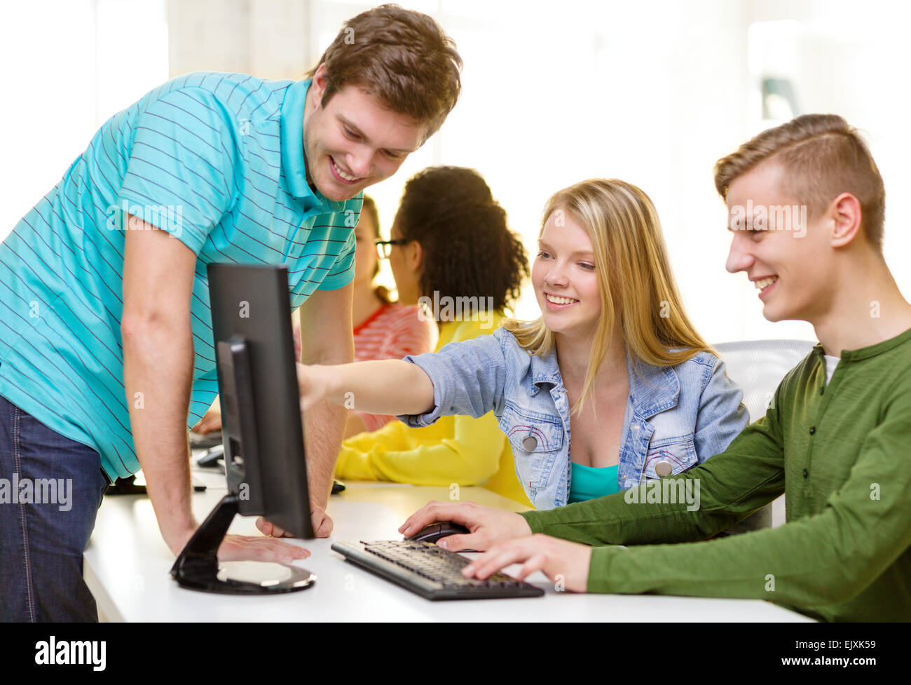 smiling students in computer class at school Stock Photo - Alamy