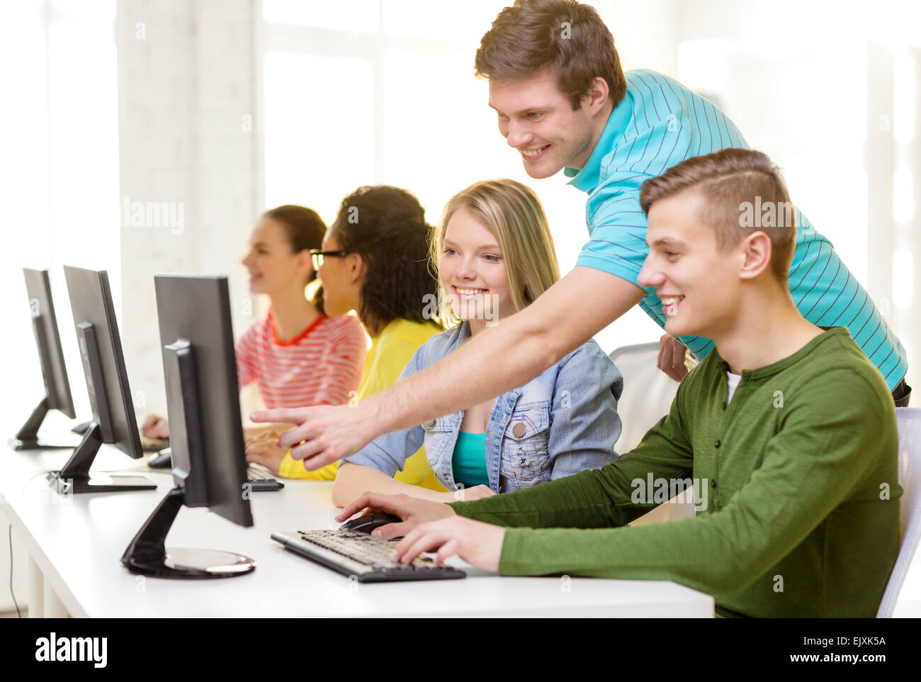 smiling students in computer class at school Stock Photo - Alamy
