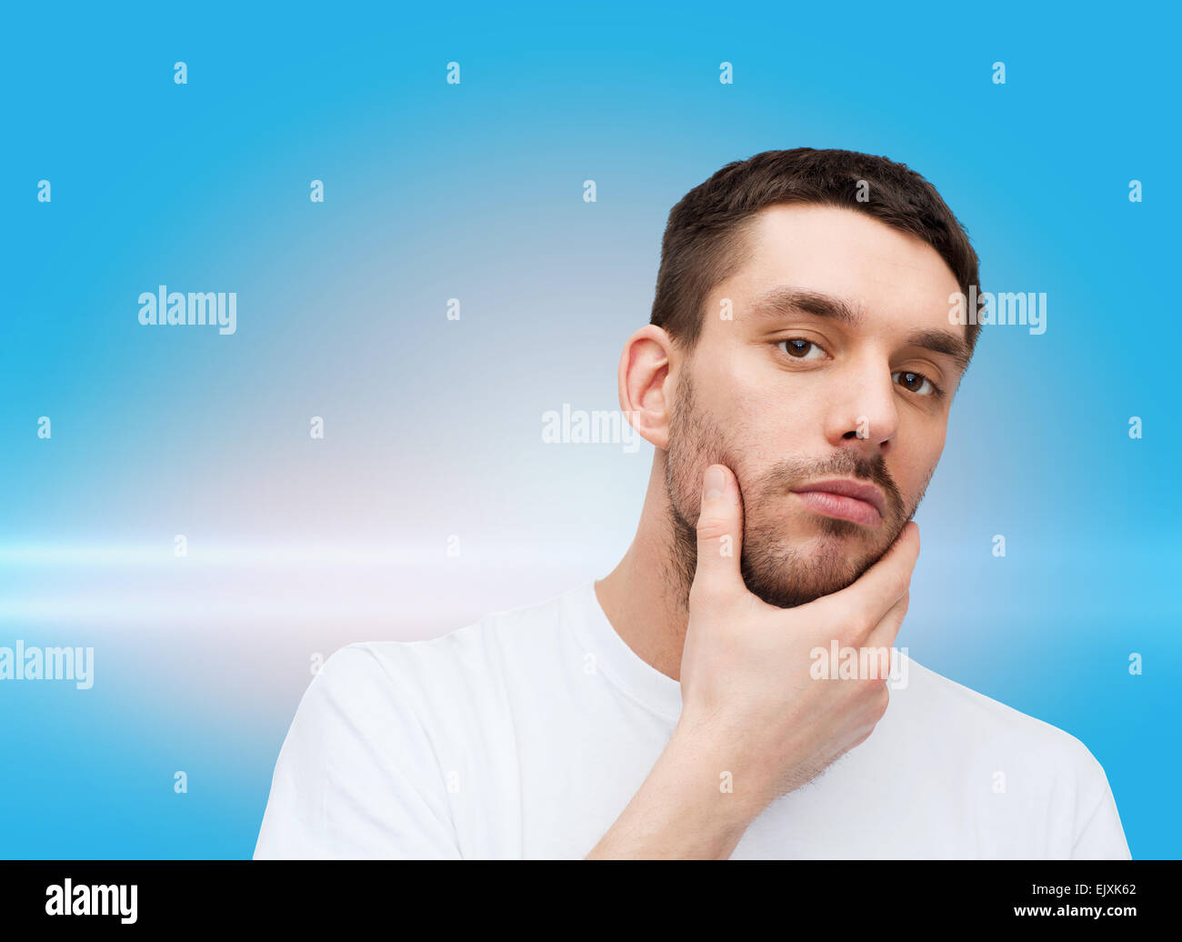 beautiful calm man touching his face Stock Photo - Alamy