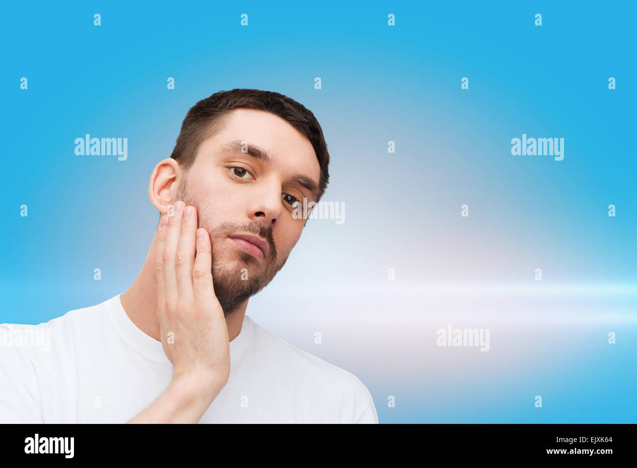 beautiful calm man touching his face Stock Photo - Alamy