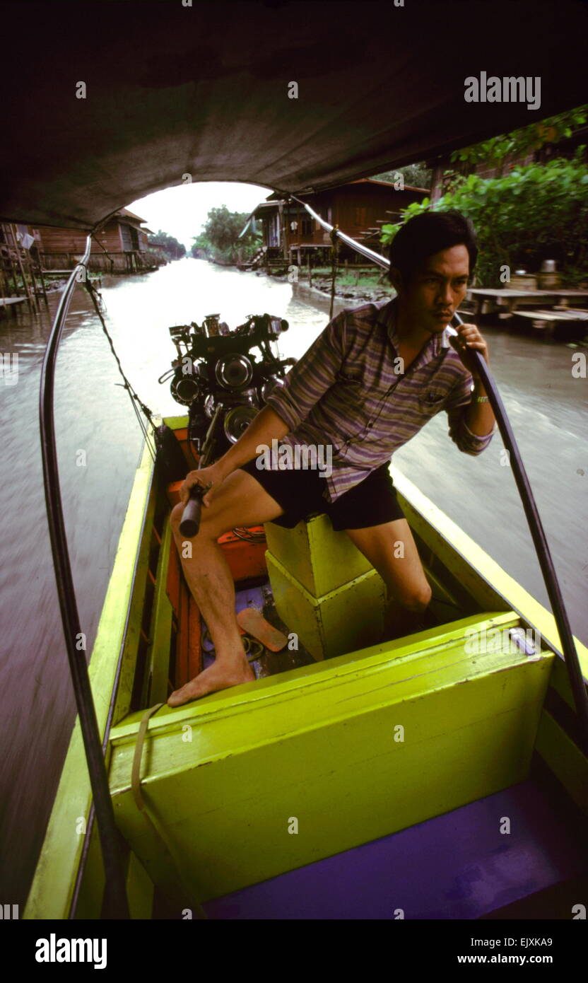 AJAXNETPHOTO - BANGKOK, THAILAND. - A BOAT DRIVER CONCENTRATES ON A ...