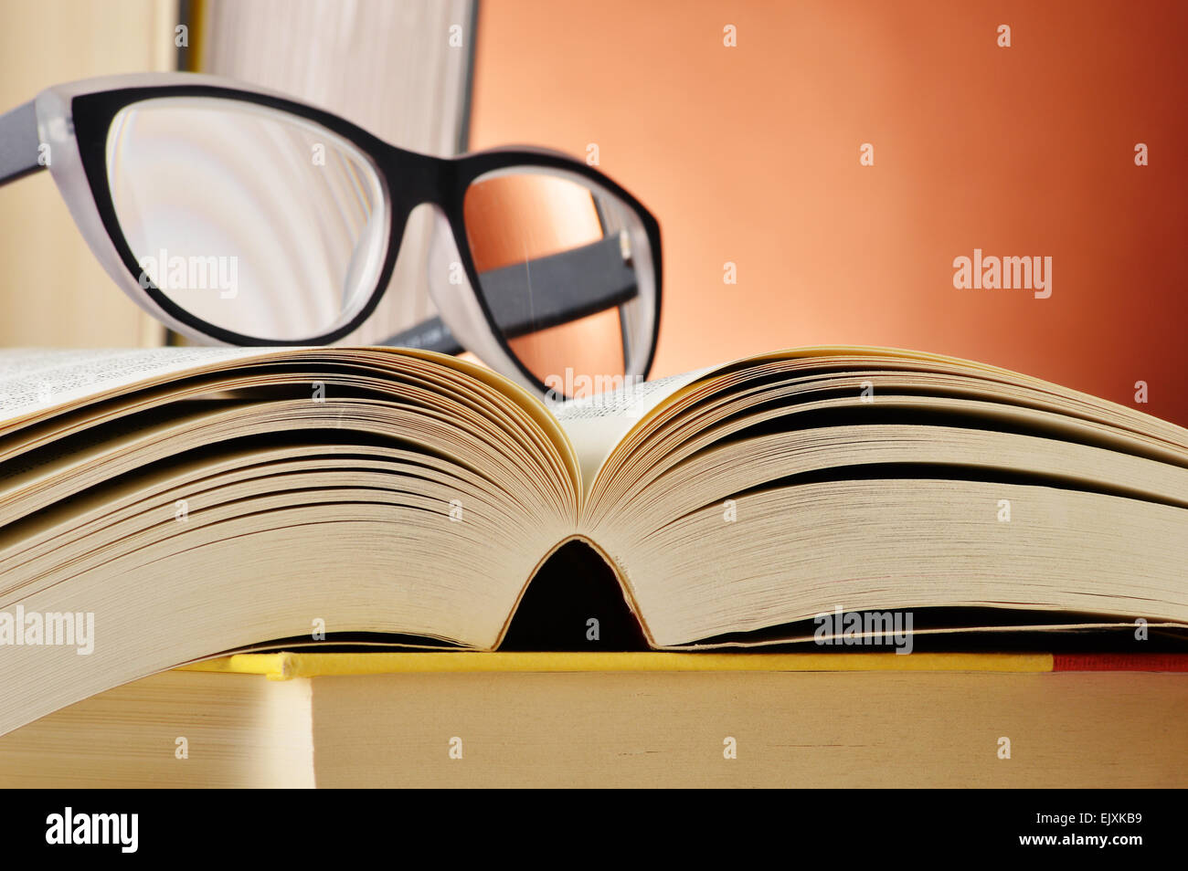 Composition with glasses and books on the table Stock Photo - Alamy