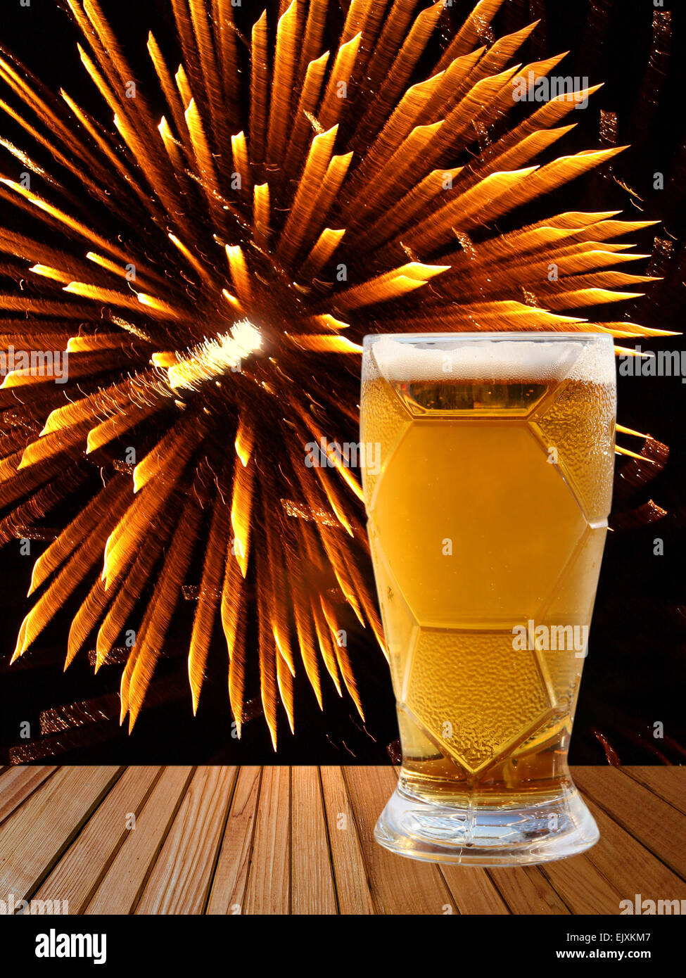 Beer glass on wooden table on golden fireworks background Stock Photo ...