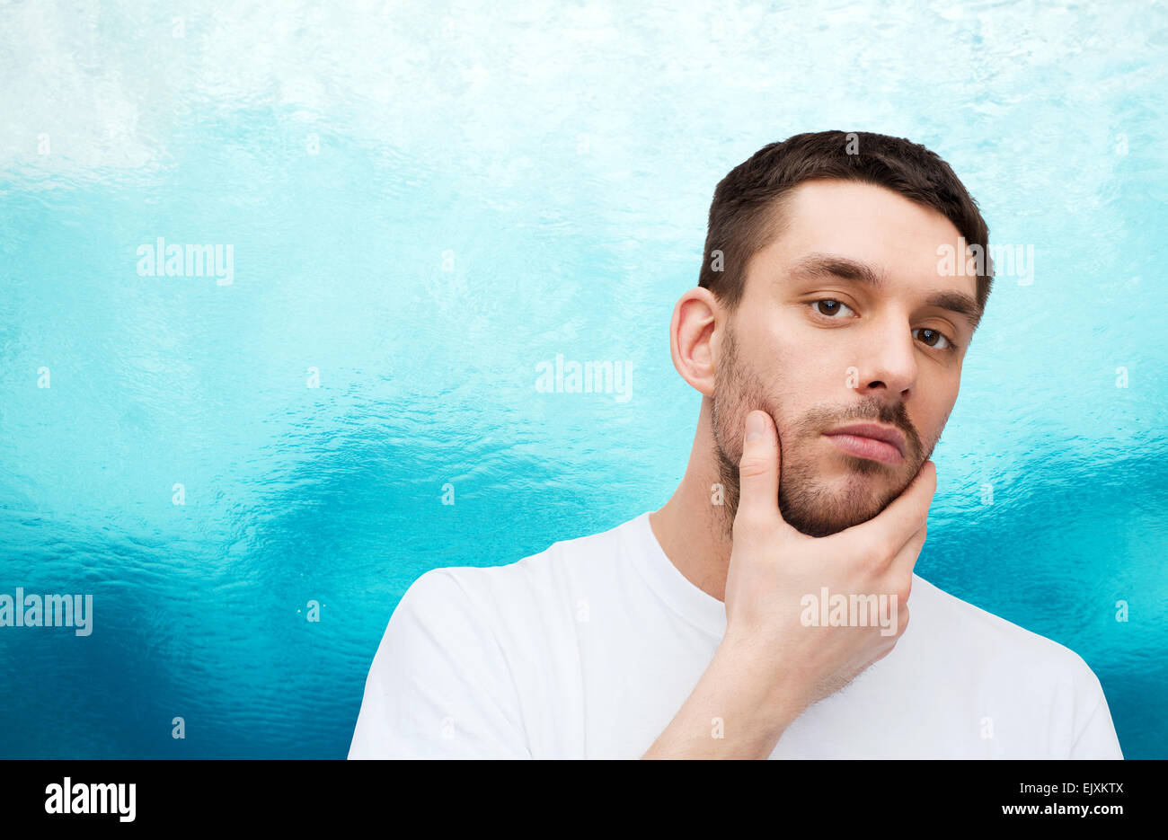beautiful calm man touching his face Stock Photo - Alamy