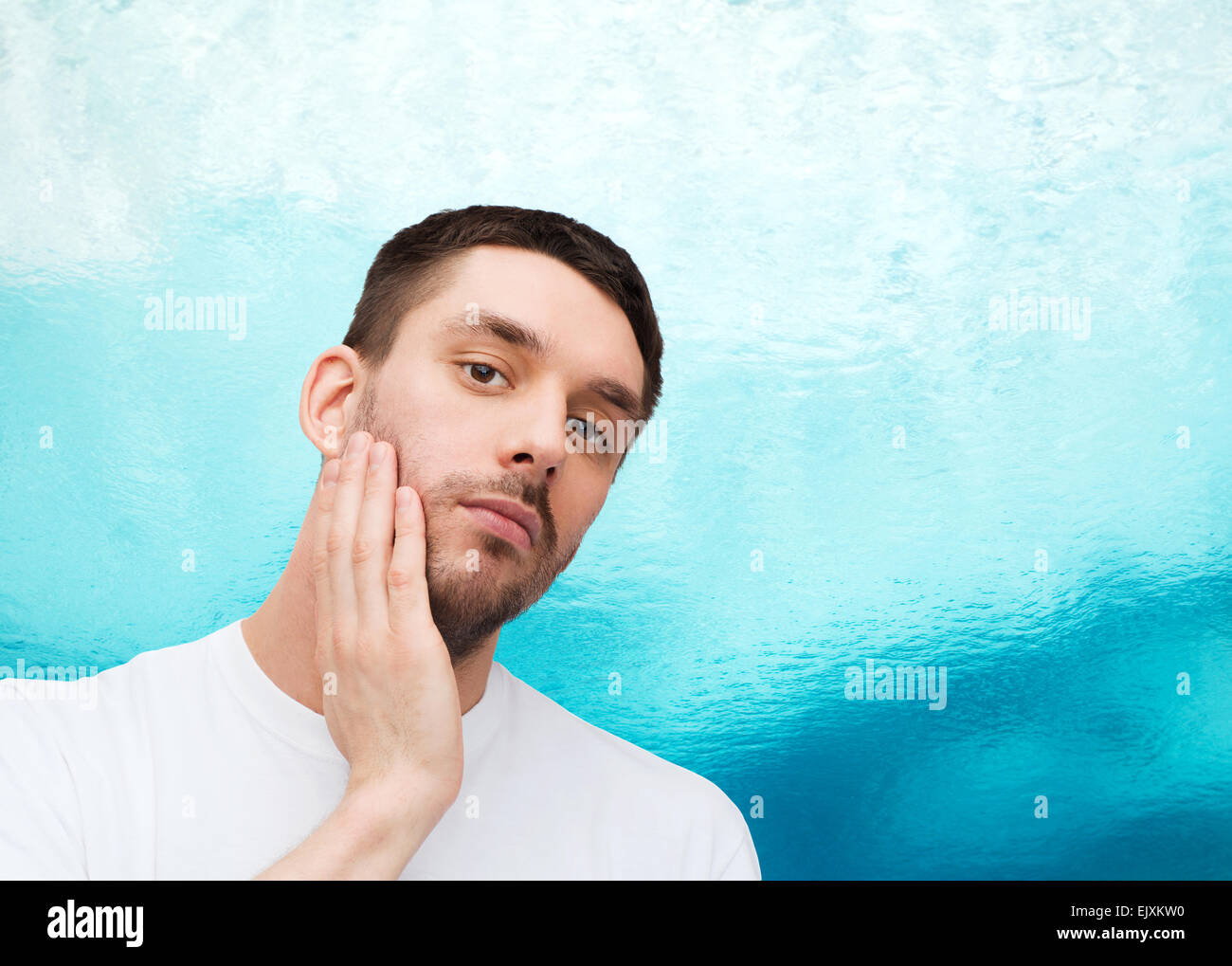 beautiful calm man touching his face Stock Photo - Alamy