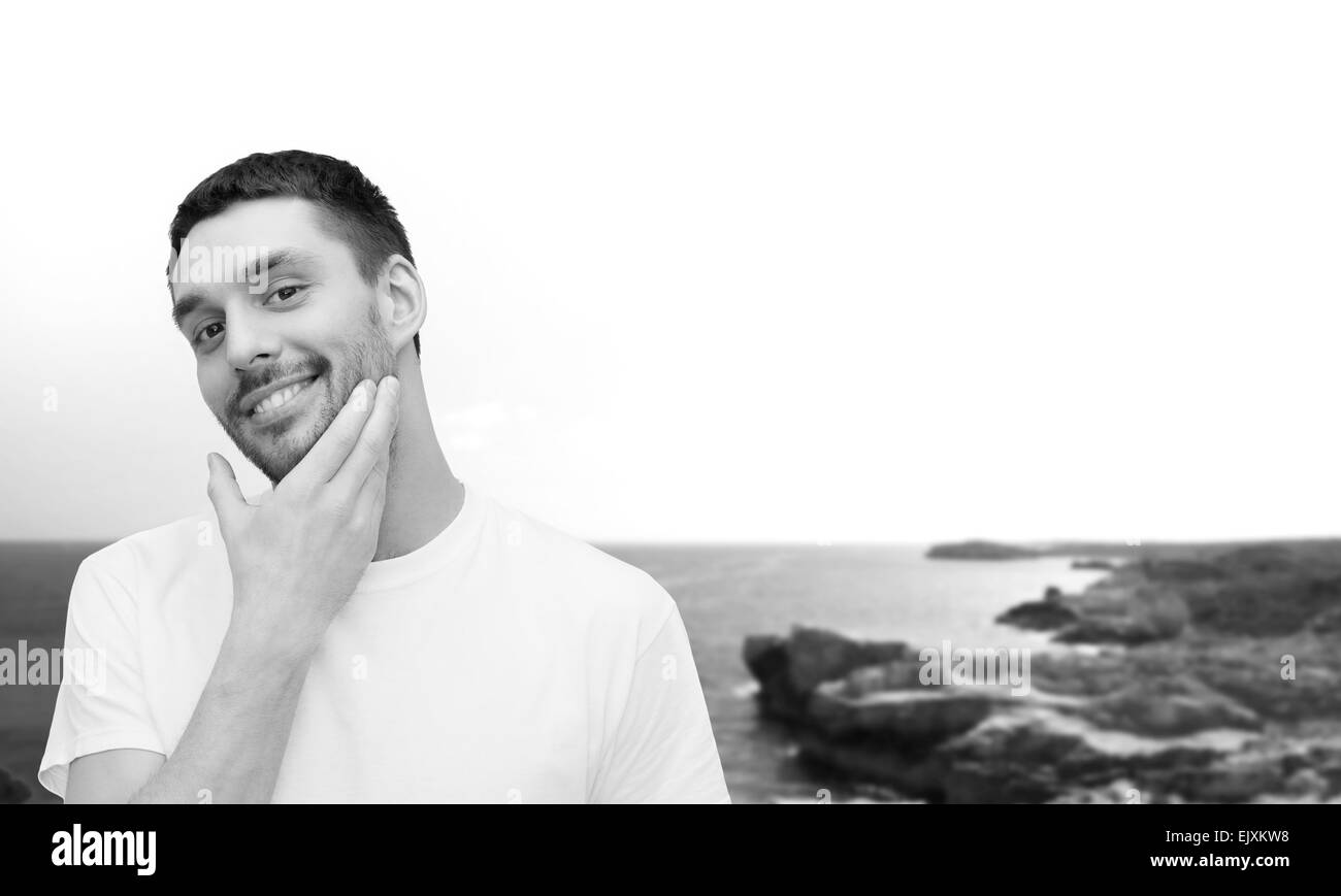 beautiful smiling man touching his face Stock Photo - Alamy
