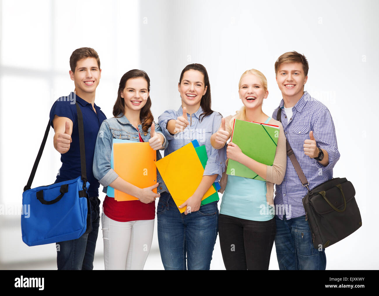group of smiling students showing thumbs up Stock Photo - Alamy