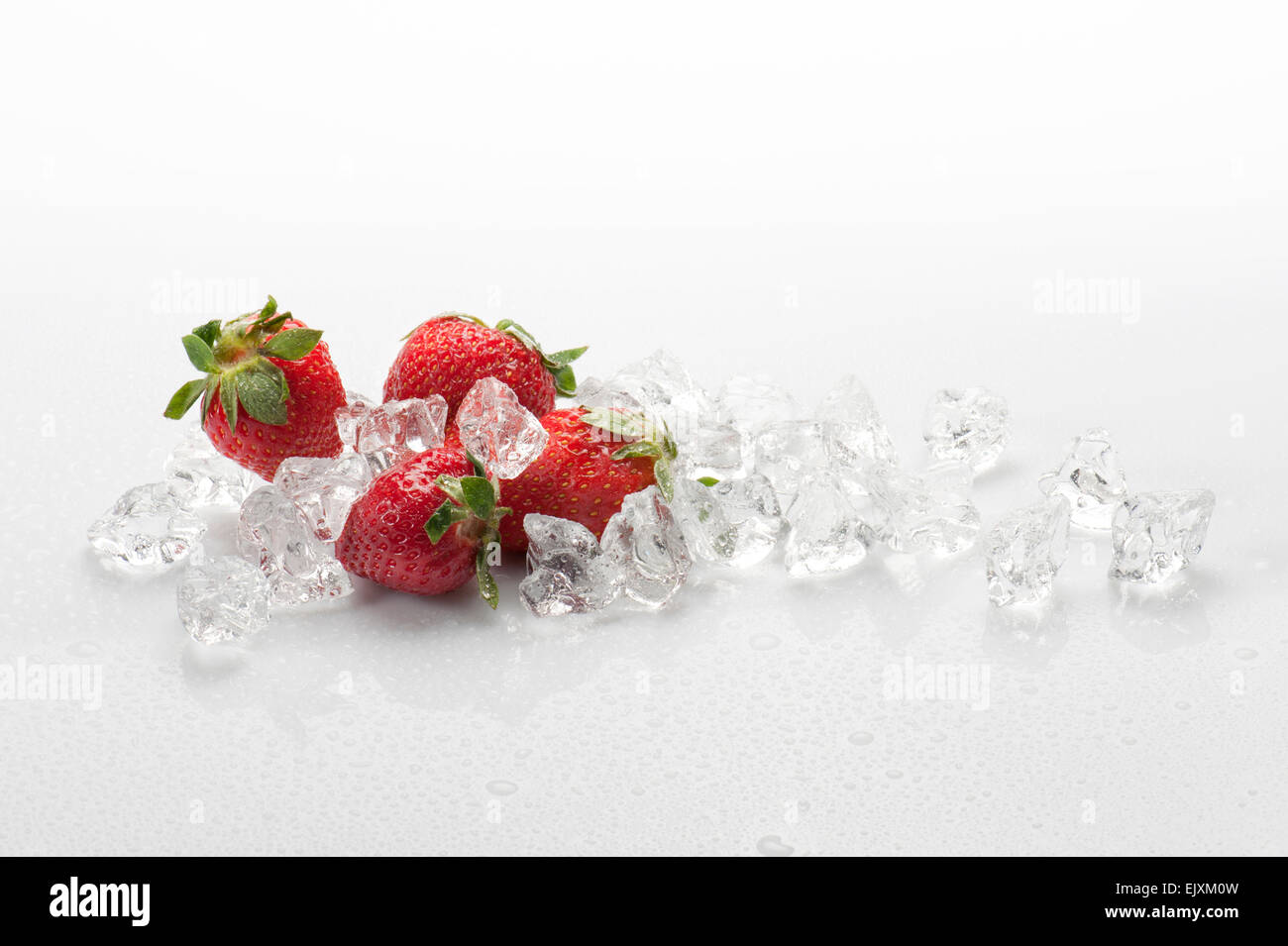 frozen strawberries with ice cubes, on white background Stock Photo - Alamy