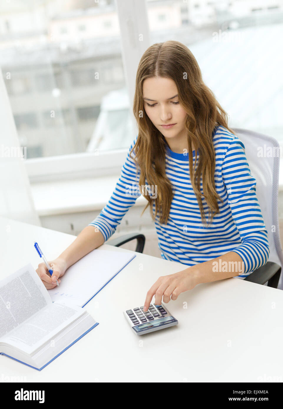 student girl with book, calculator and notebook Stock Photo - Alamy