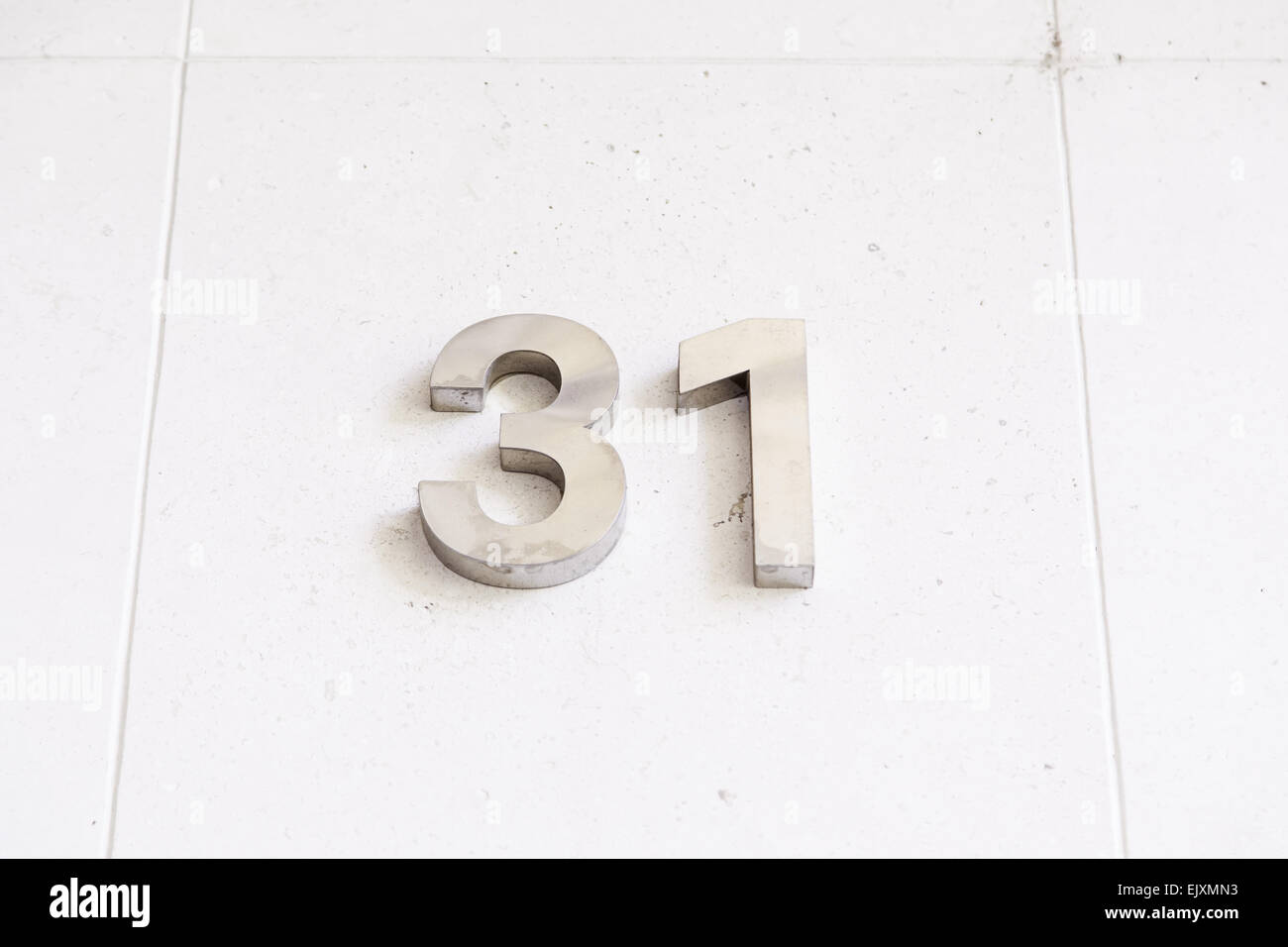 Number thirty-one on a wall, detail of a number of information, odd ...