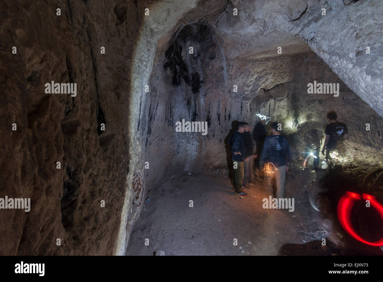 Azeka, Israel. People in a 2000-year old artificial cave Stock Photo ...