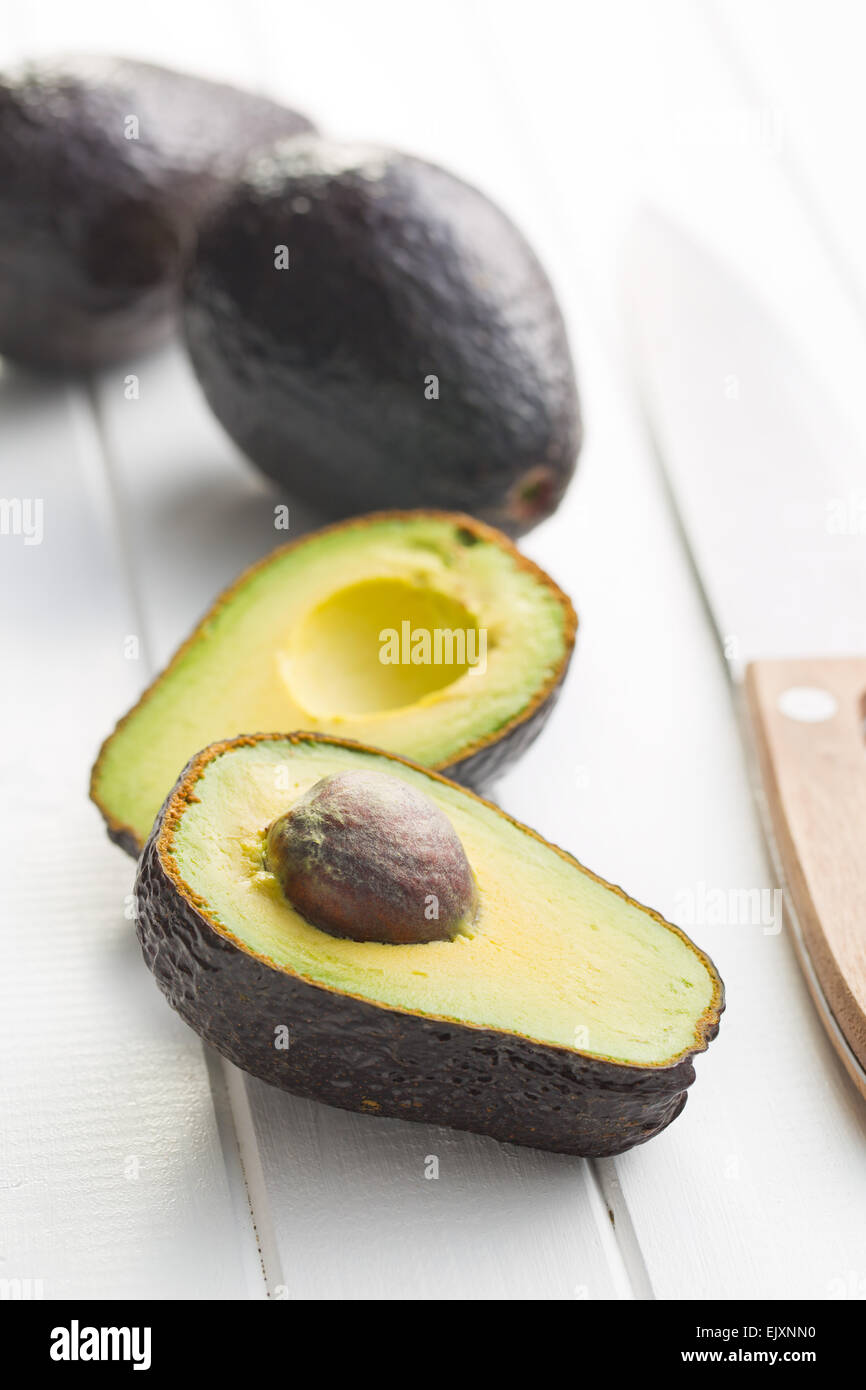 halved avocado on white table Stock Photo - Alamy