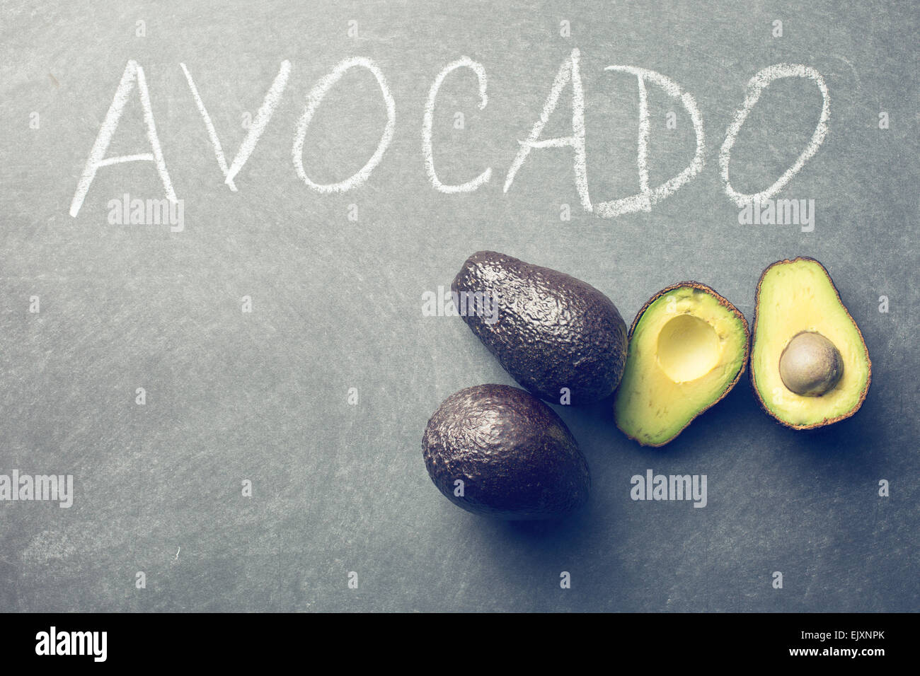 the halved avocado on blackboard Stock Photo - Alamy