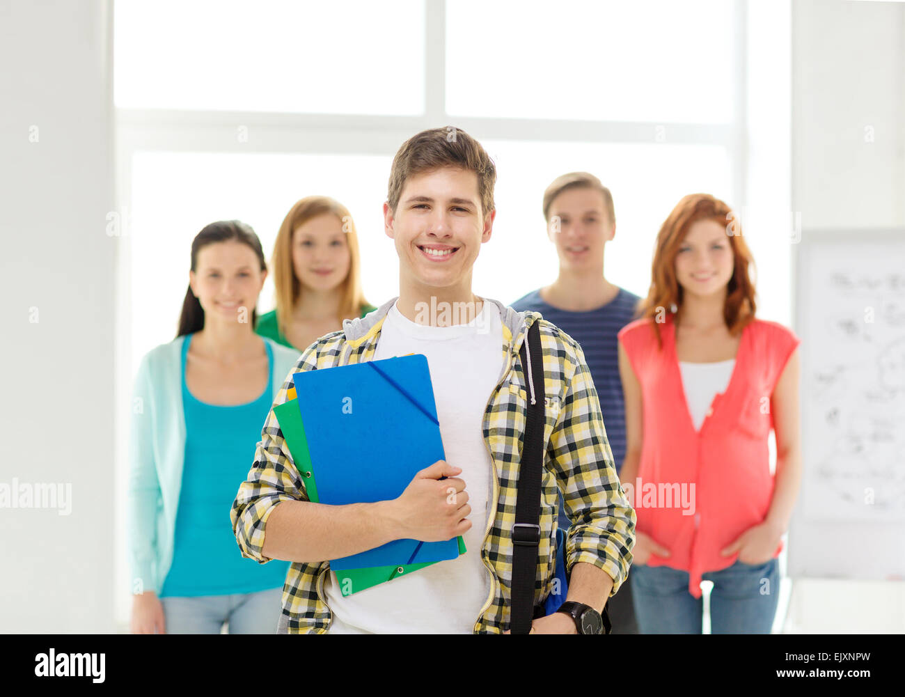 smiling students with teenage boy in front Stock Photo - Alamy