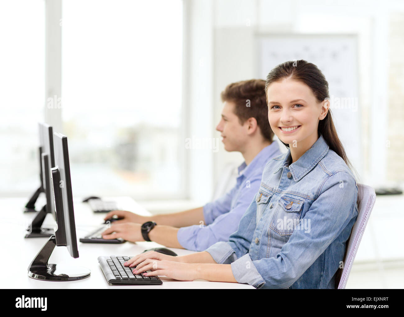 two smiling students in computer class Stock Photo - Alamy