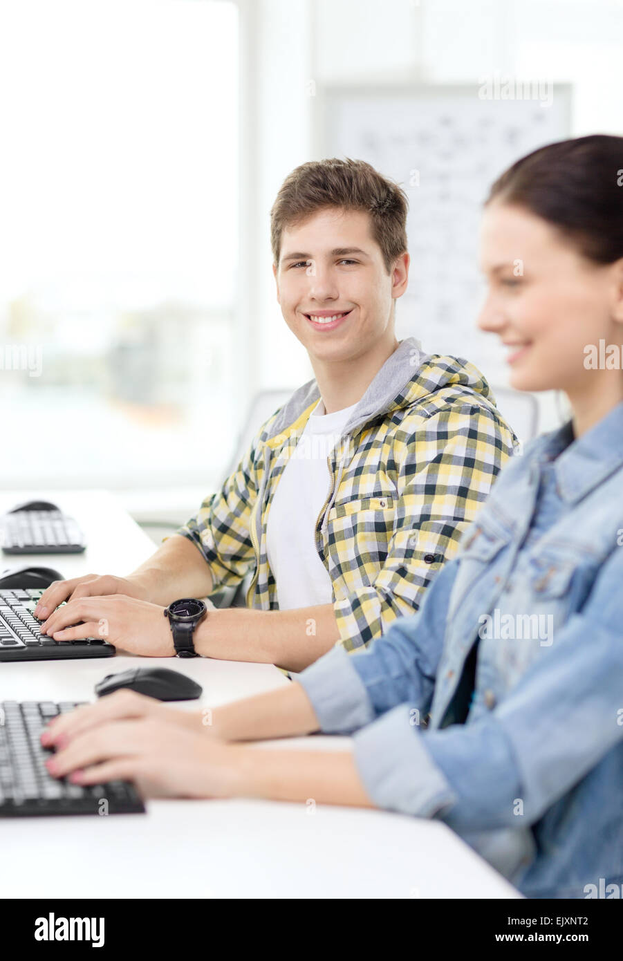 smiling boy with girl in computer class at school Stock Photo - Alamy