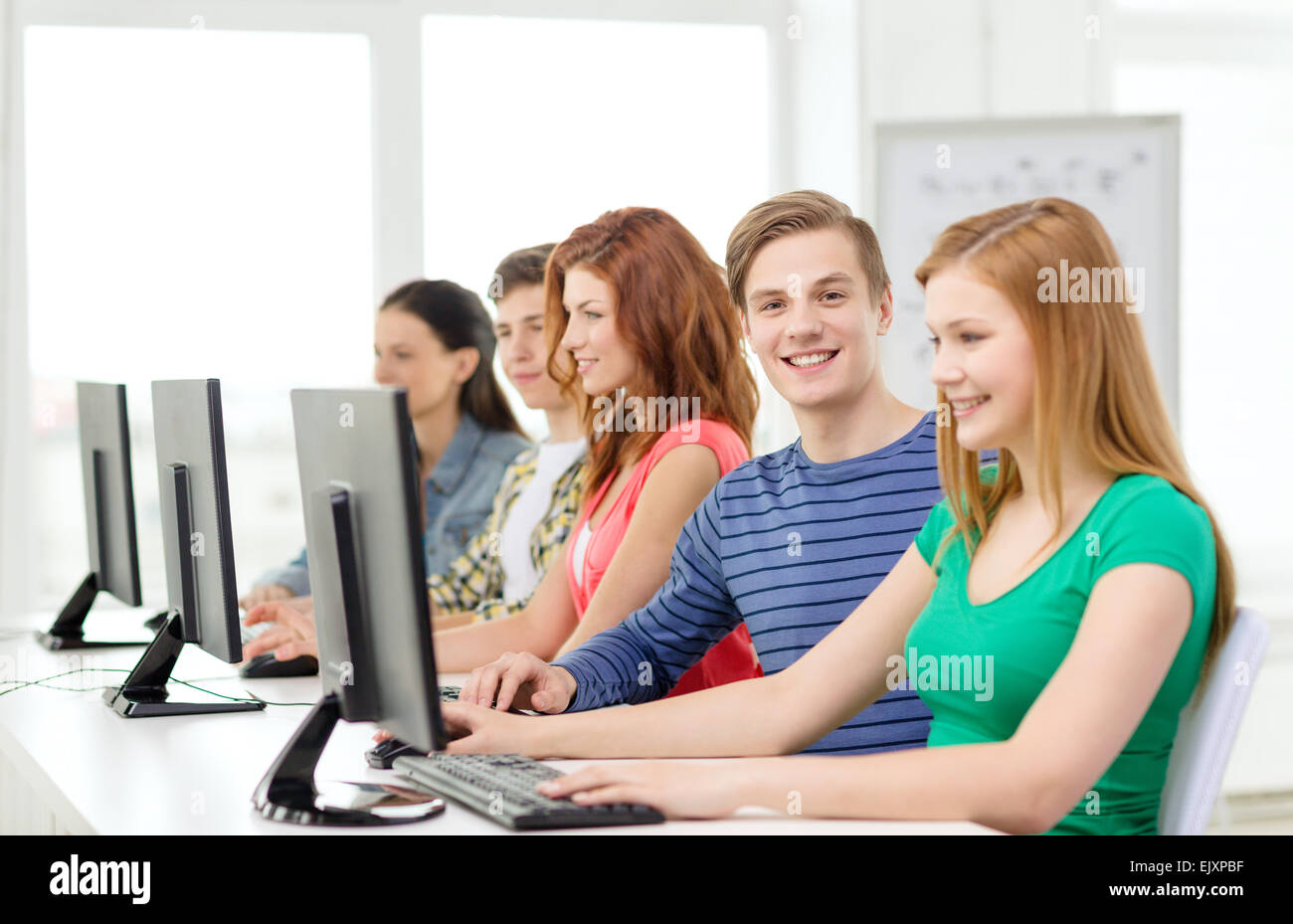 smiling student with computer studying at school Stock Photo - Alamy