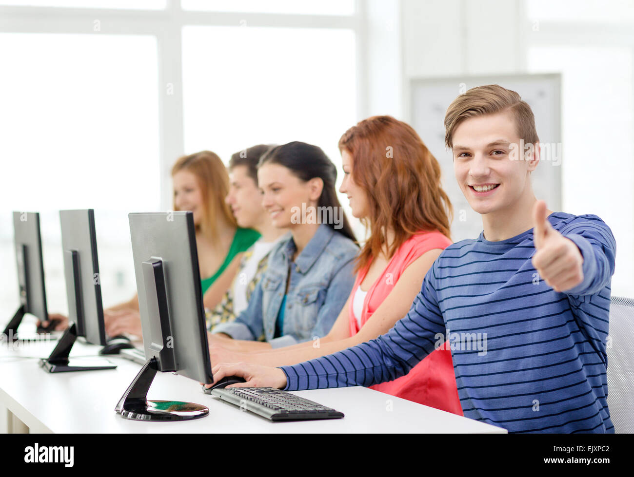 male student with classmates in computer class Stock Photo - Alamy