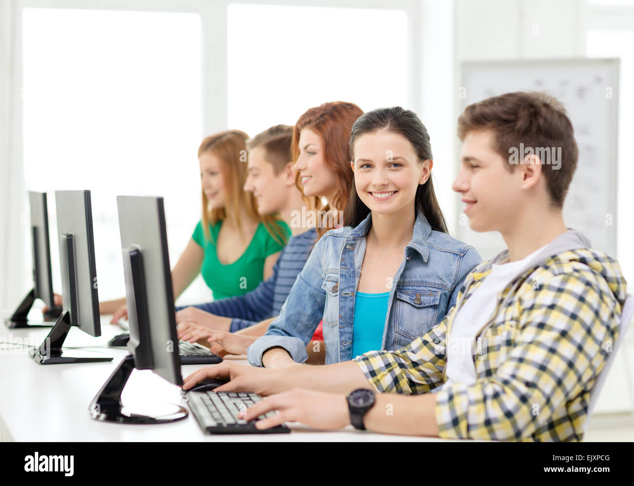 smiling student with computer studying at school Stock Photo - Alamy