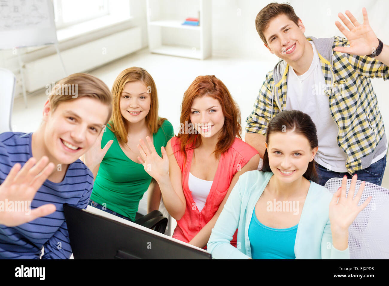 group of smiling students waving hands at school Stock Photo - Alamy
