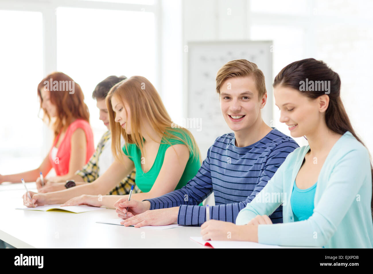 smiling students with textbooks at school Stock Photo - Alamy