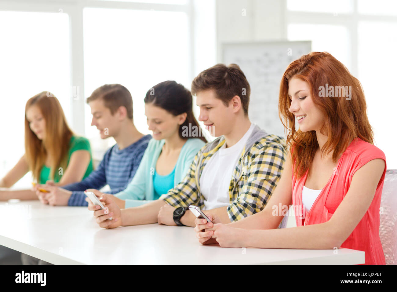 smiling students with smartphones at school Stock Photo - Alamy