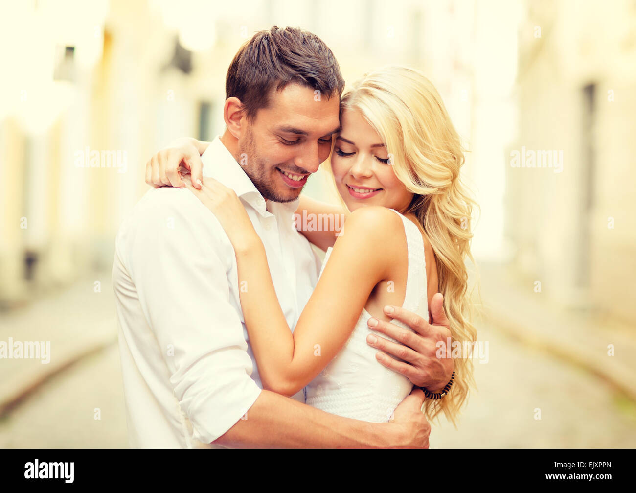 romantic happy couple hugging in the street Stock Photo - Alamy