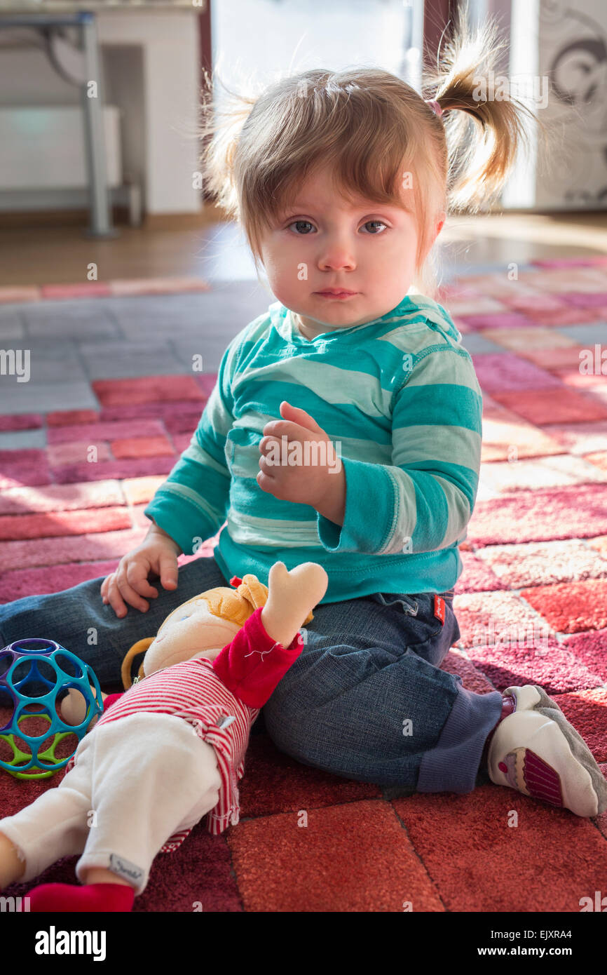 Little girl with toys Stock Photo - Alamy