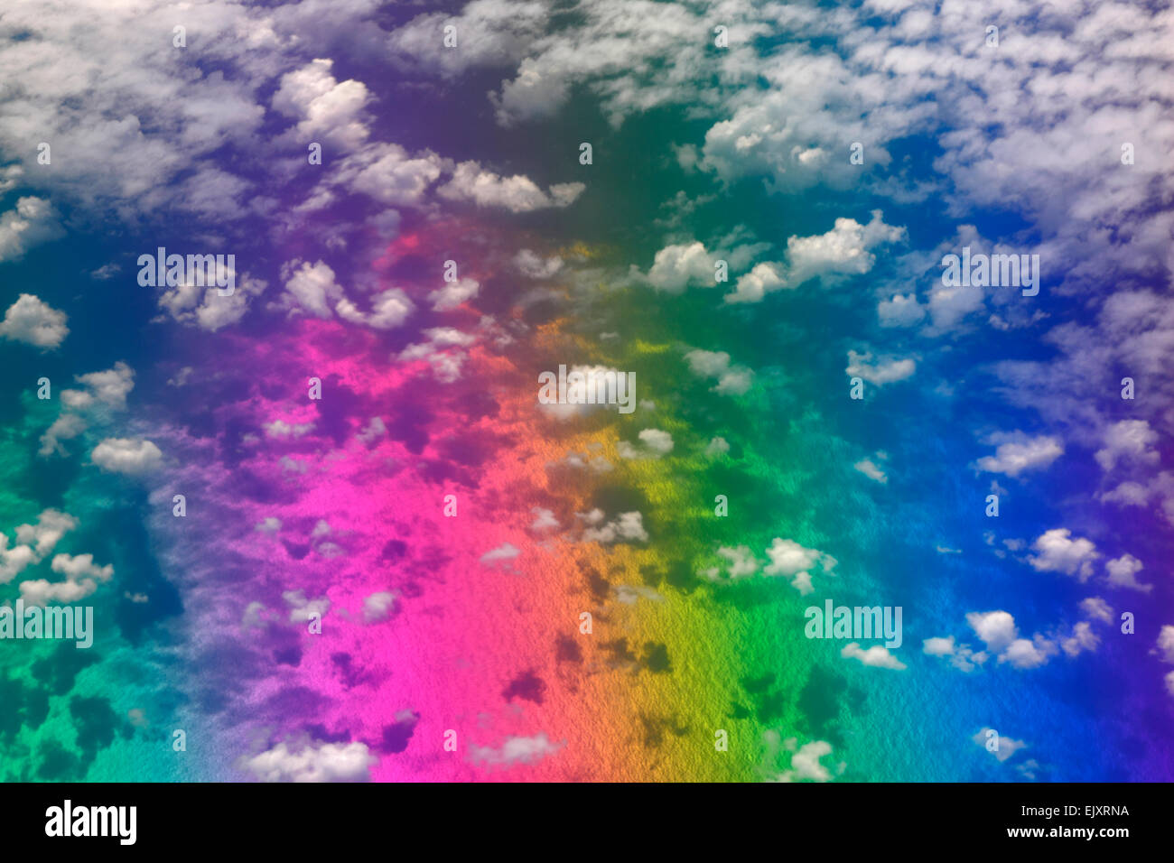 Rainbow colors over the ocean surface with clouds above Stock Photo - Alamy