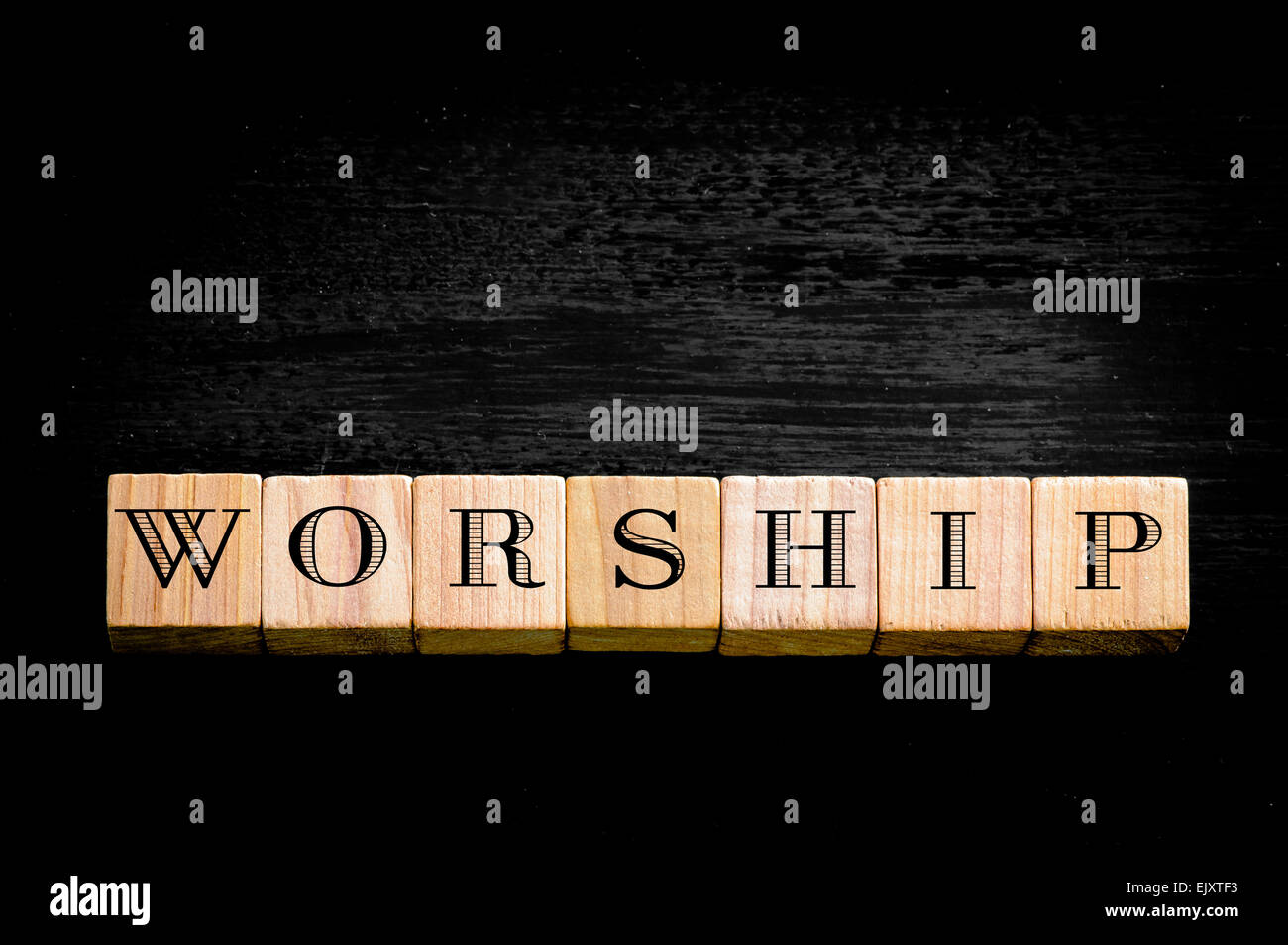 Word Worship.Wooden small cubes with letters isolated on black ...