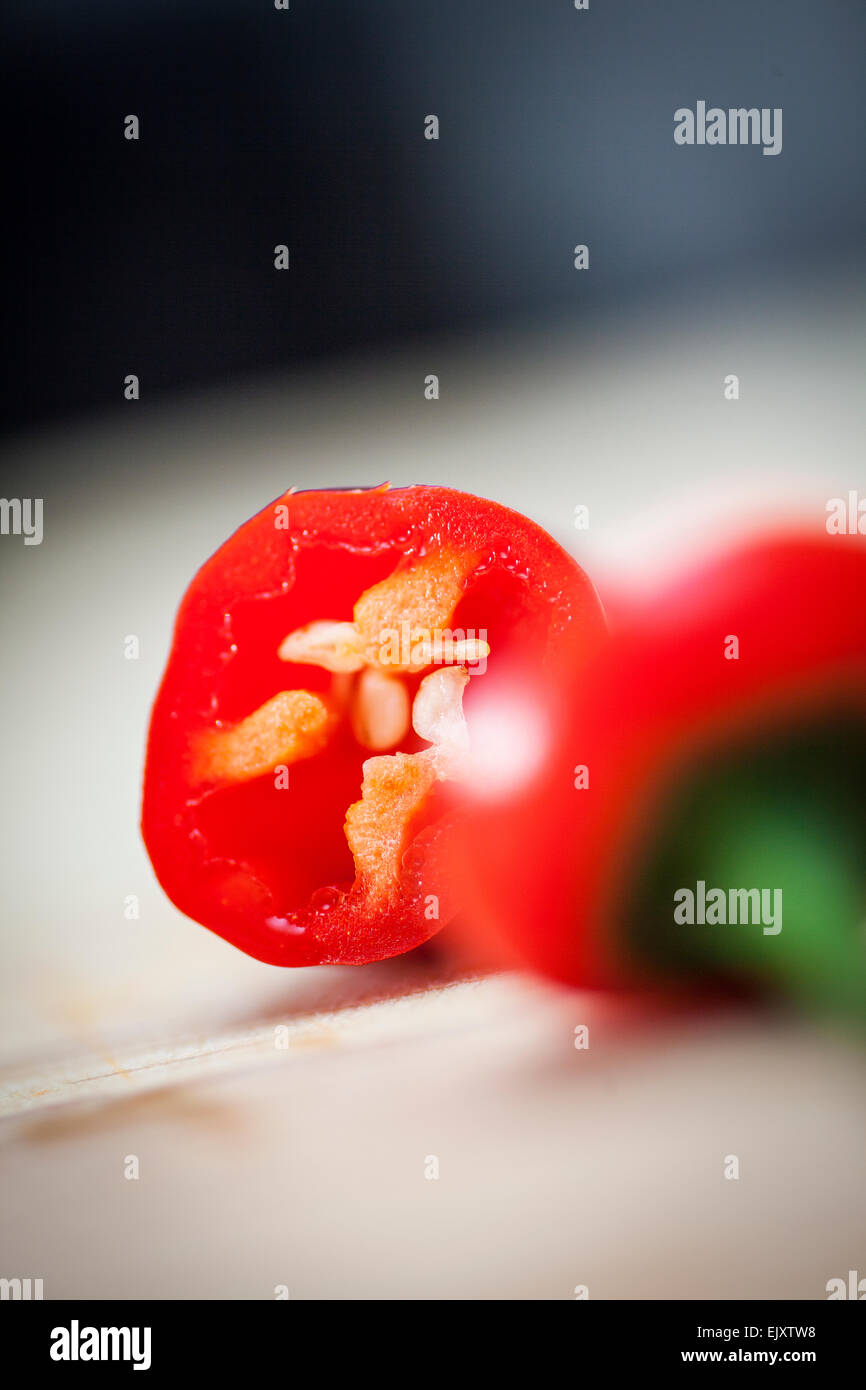 Red chilli pepper cut through the middle with the seeds showing Stock ...
