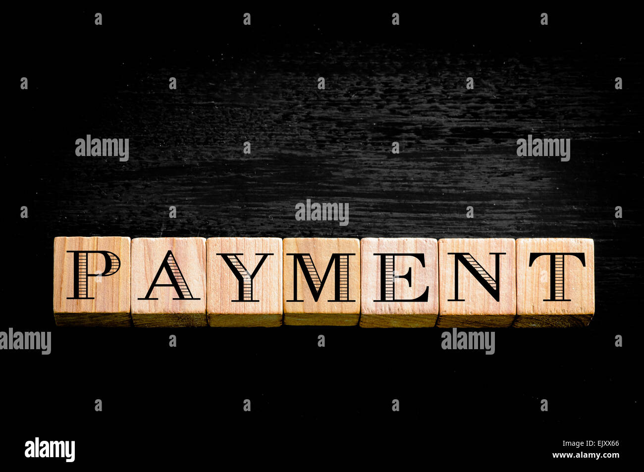 Word Payment.Wooden small cubes with letters isolated on black ...
