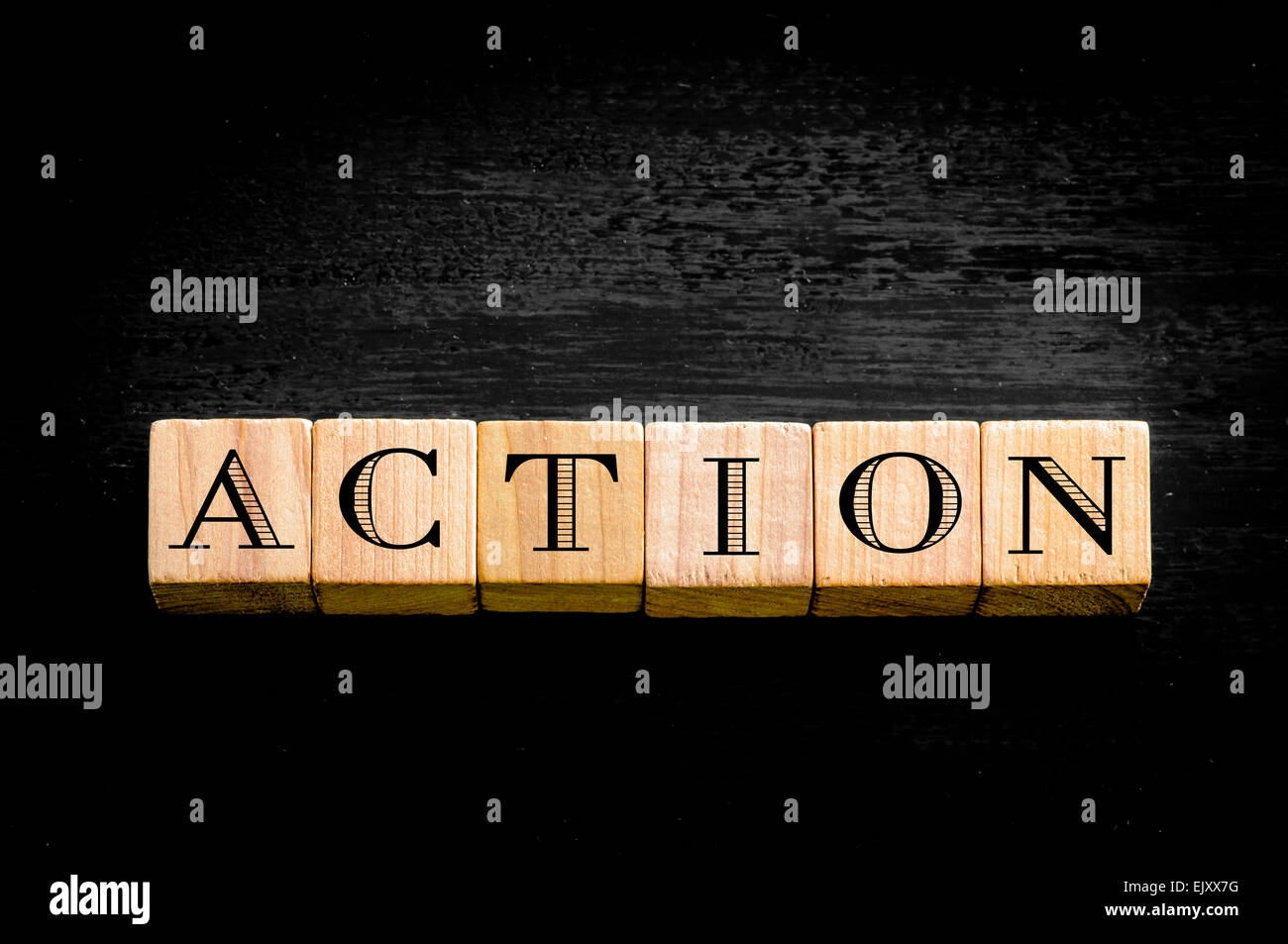 Word Action. Wooden small cubes with letters isolated on black ...