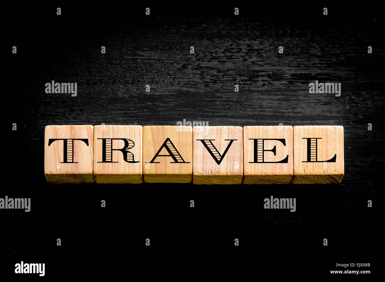 Word Travel. Wooden small cubes with letters isolated on black ...