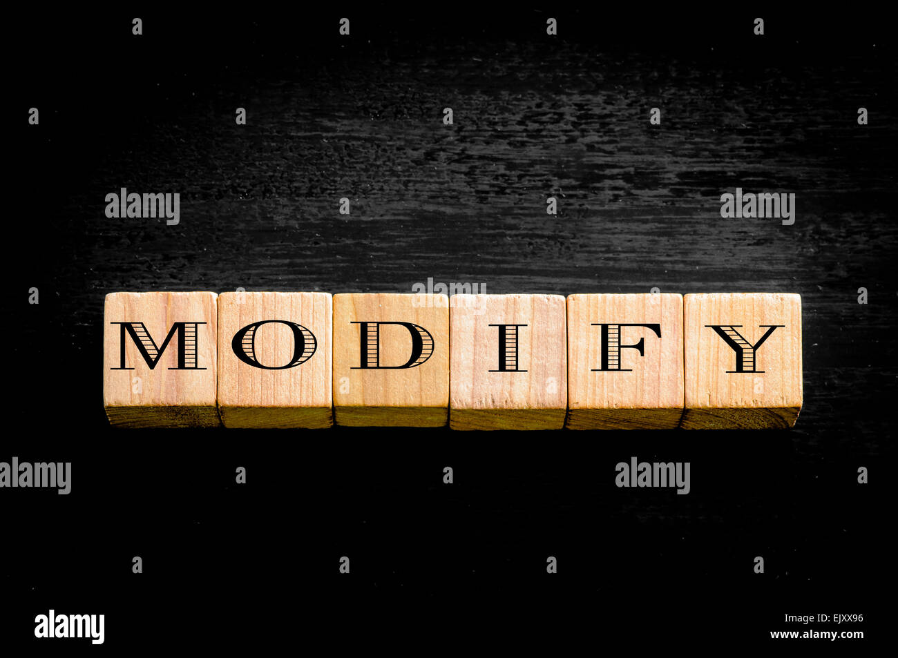 Word Modify. Wooden small cubes with letters isolated on black ...