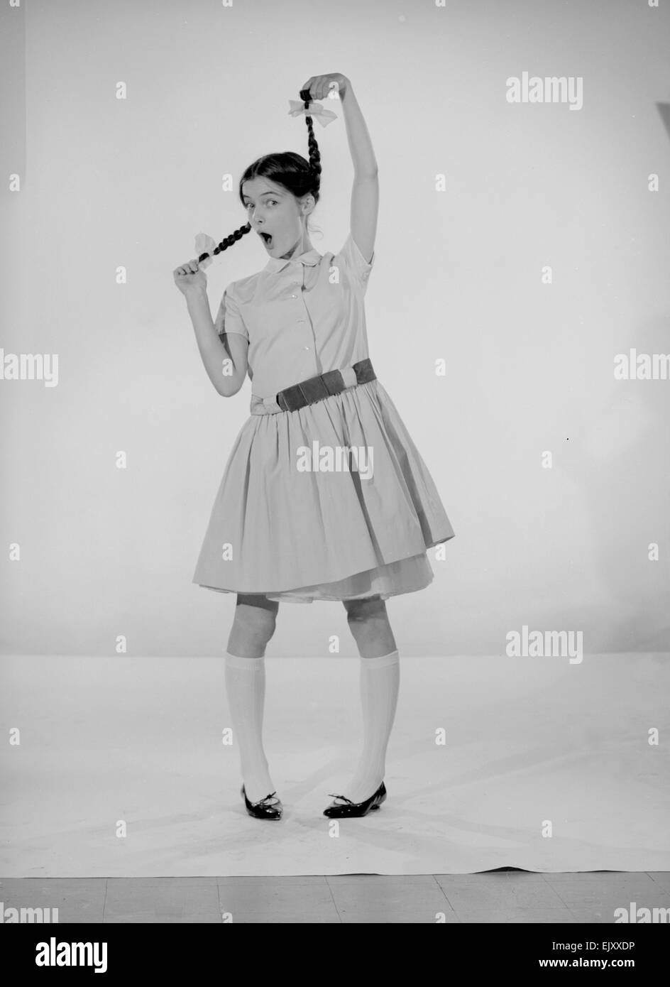 Model Jennifer Goddard. Brown-haired girl in checkered dress with pig ...