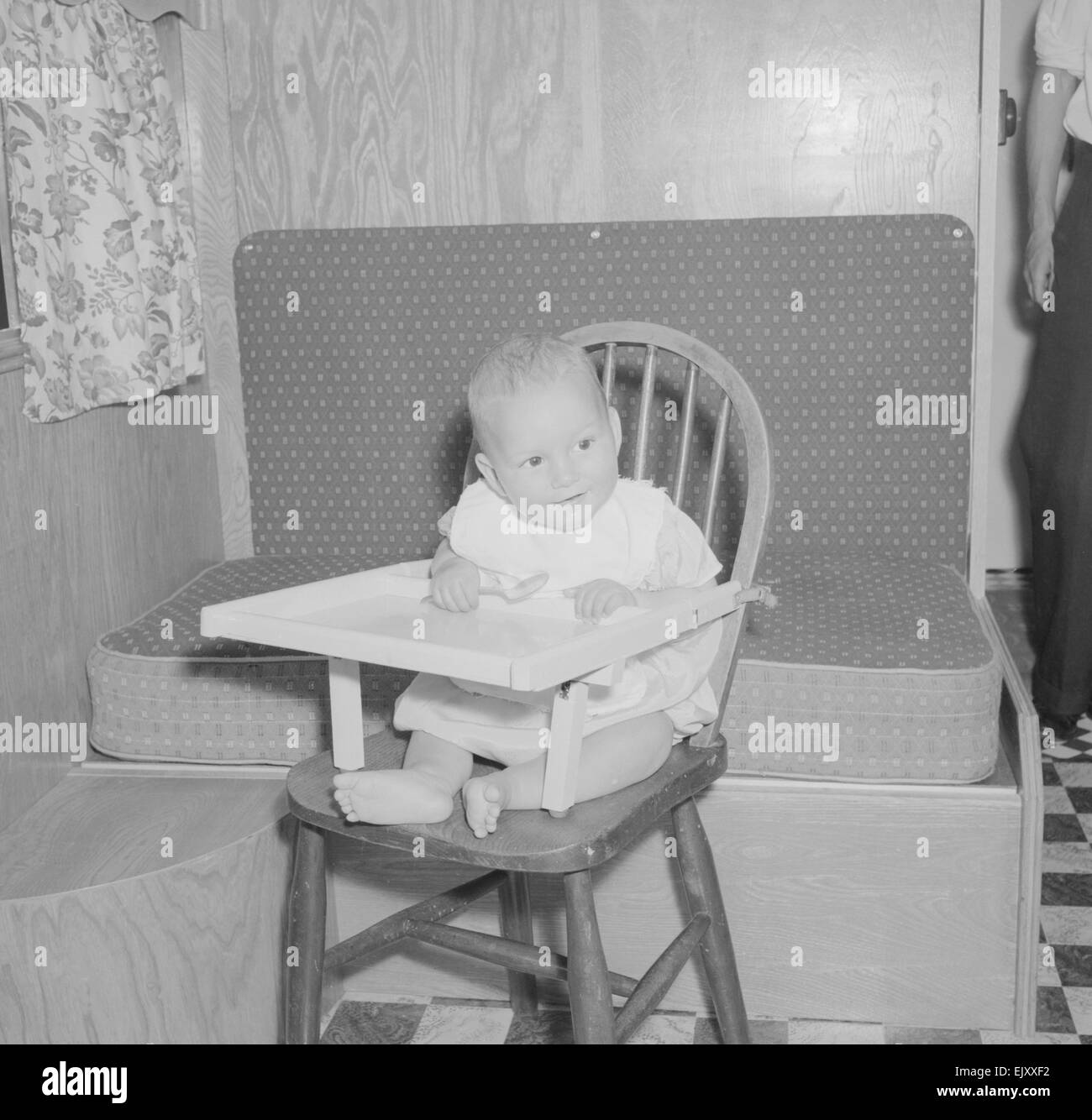 Baby in high chair Circa 1959 Stock Photo - Alamy