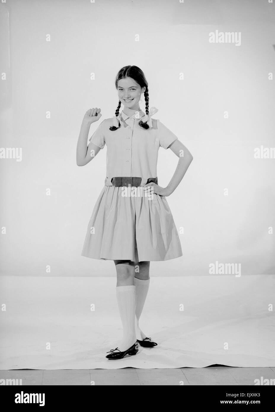 Model Jennifer Goddard. Brown-haired girl in checkered dress with pig ...