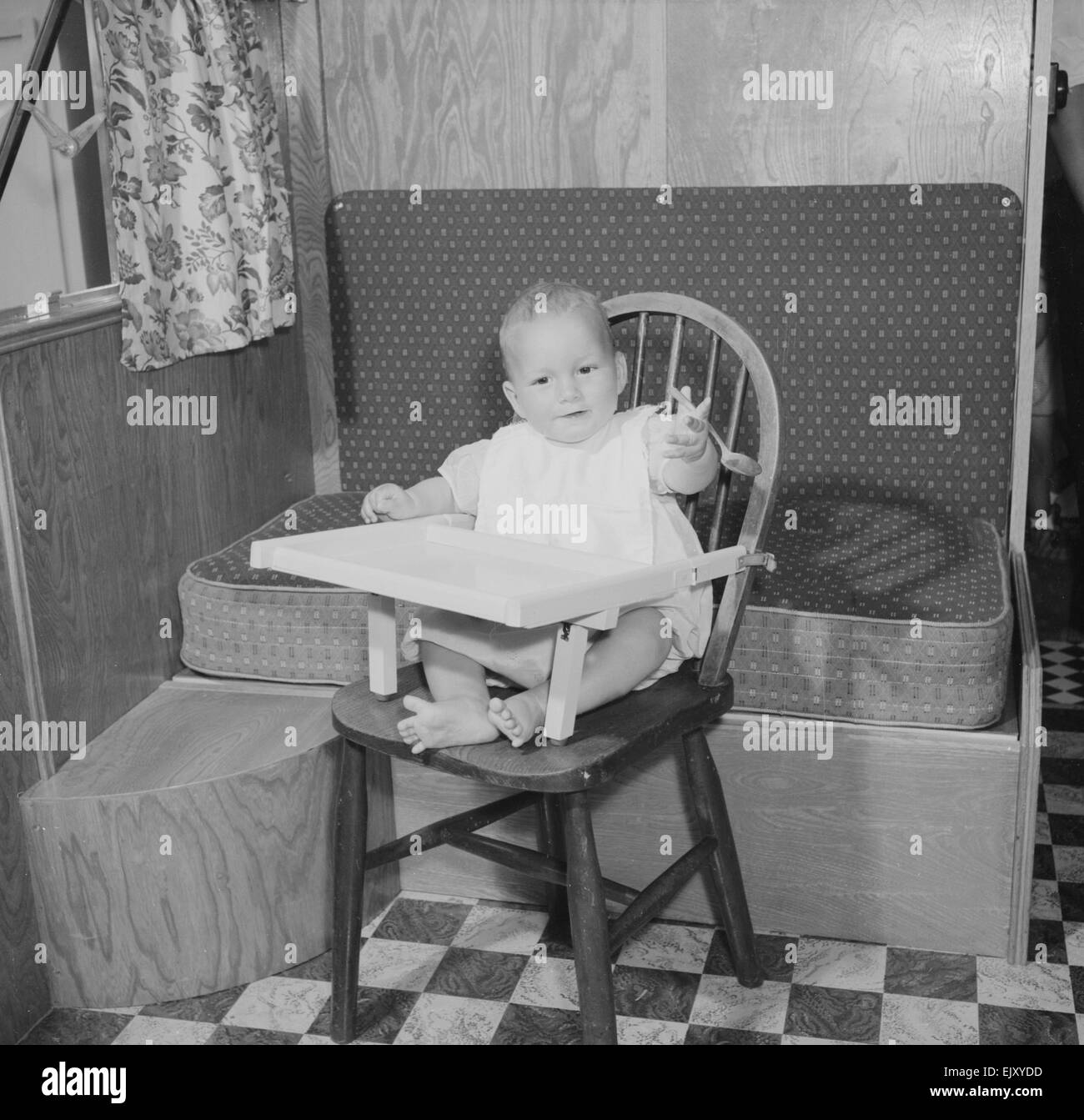 Baby in high chair Circa 1959 Stock Photo - Alamy
