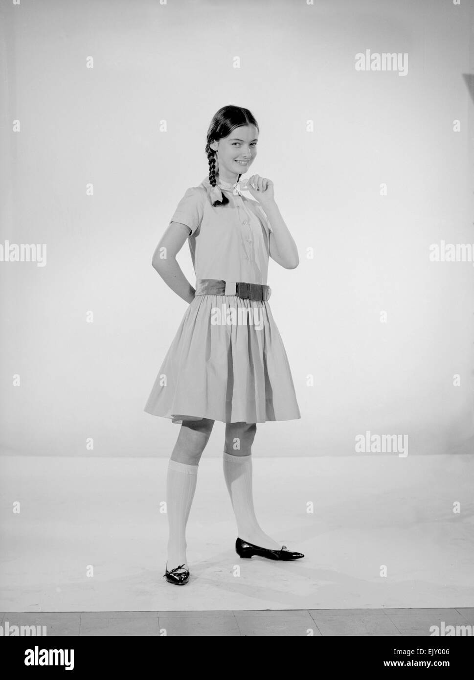 Model Jennifer Goddard. Brown-haired girl in checkered dress with pig ...