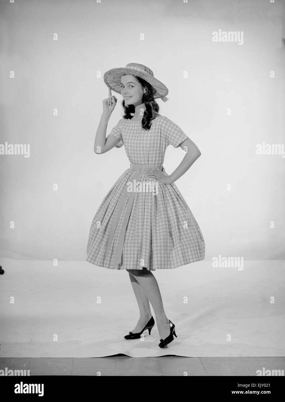 Model Jennifer Goddard. Brown-haired girl in checkered dress with hat ...