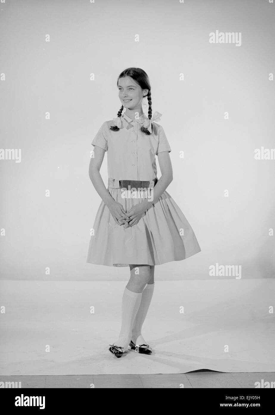 Model Jennifer Goddard. Brown-haired girl in checkered dress with pig ...