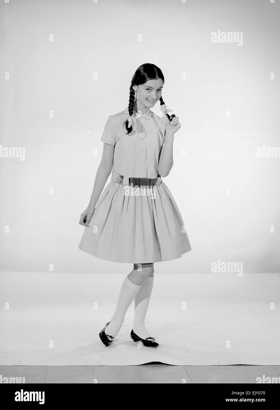 Model Jennifer Goddard. Brown-haired girl in checkered dress with pig ...