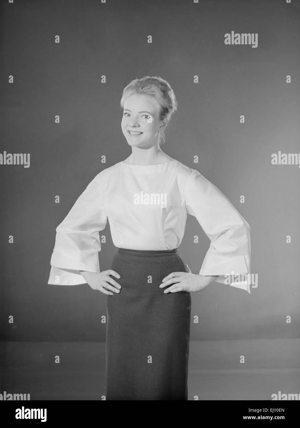 Model Valerie Hollman wearing white blouse and dark skirt Stock Photo ...